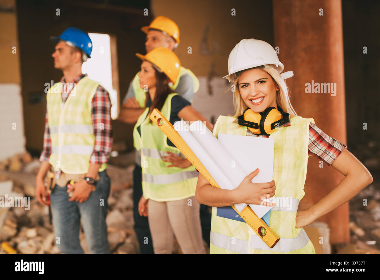 Beautiful young female construction architect at a construction site ...