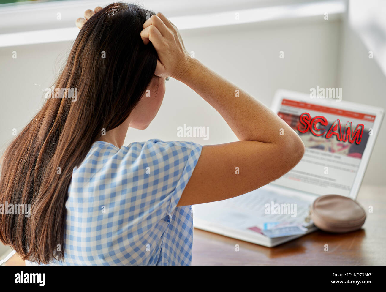 Woman realising her her accounts have been scammed Stock Photo - Alamy