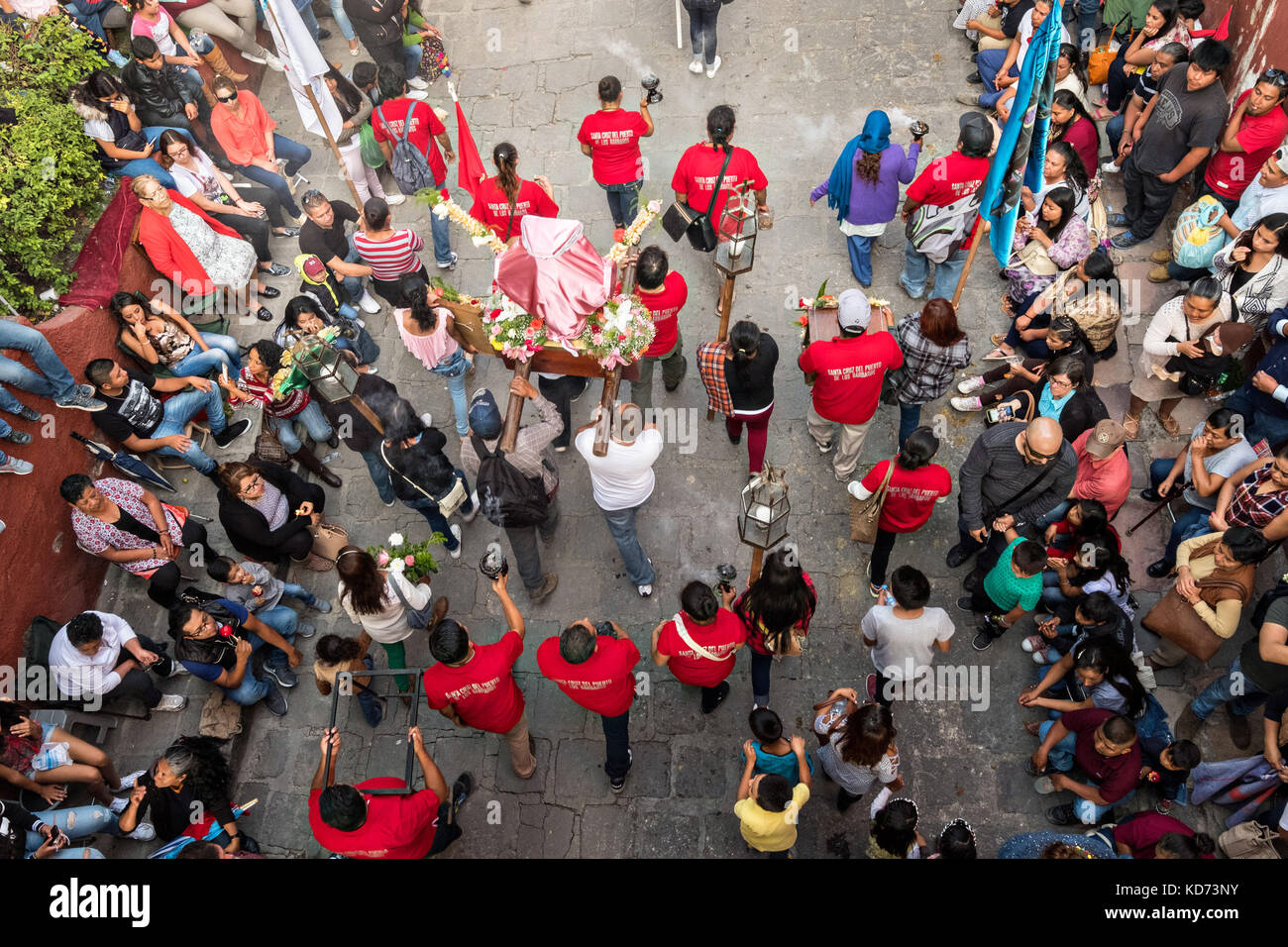 A religious procession carries a statue of St Michael through the ...