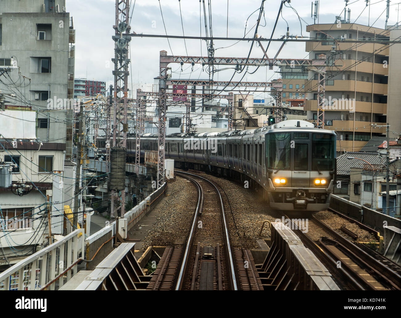 The train pass through a industrial area of the city. View of the ...