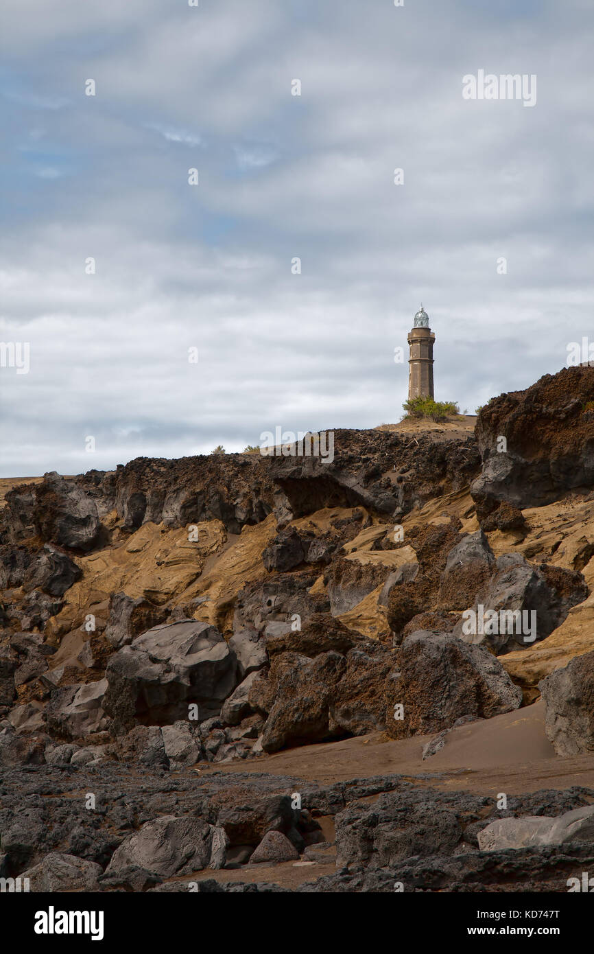 Lighthouse Capelinhos on the shore of the volcanic island Faial, Azores ...