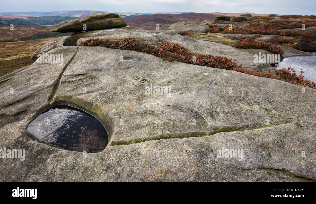Numbered carved rock basin on Stanage Edge near Hathersage in the ...