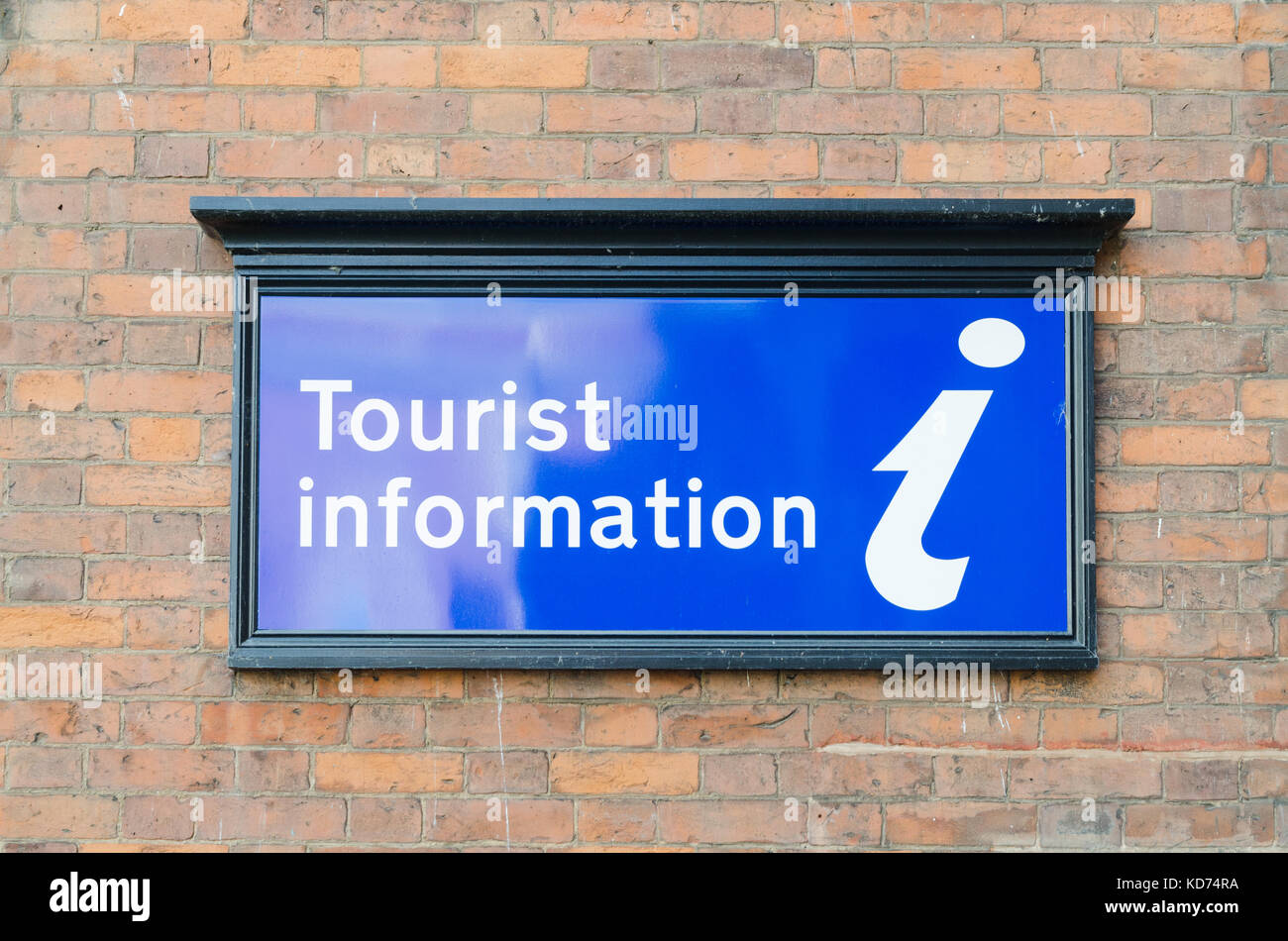 Large blue sign on brick wall outside Tourist Information office at the ...