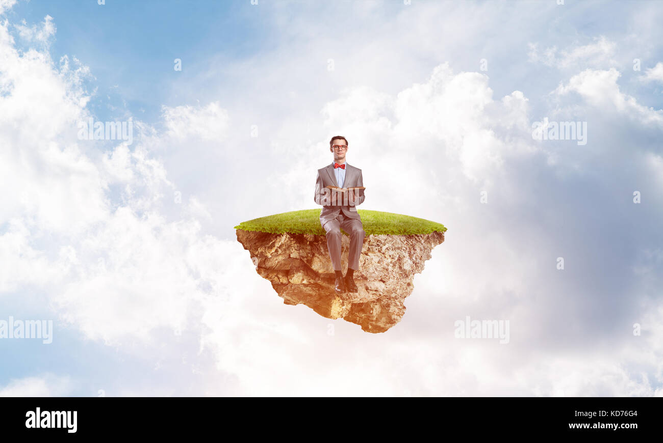 Young businessman or student floating in sky and studying the science ...