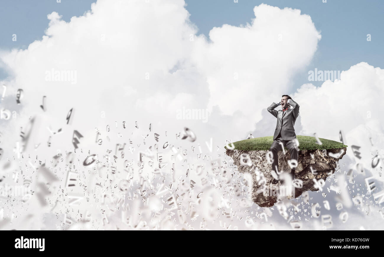 Young man floating in sky and dont want to hear anything Stock Photo ...