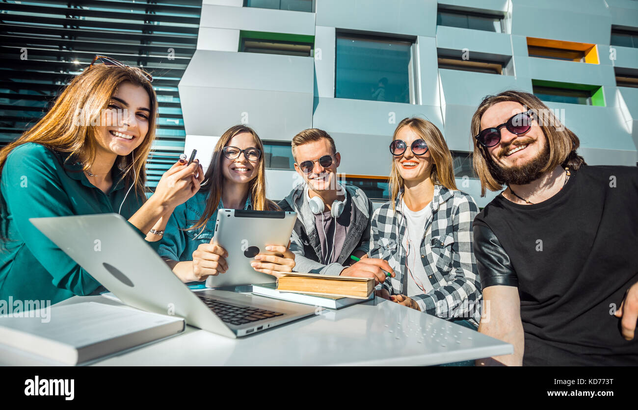 Group of students have study talk on table with laptop and books before ...