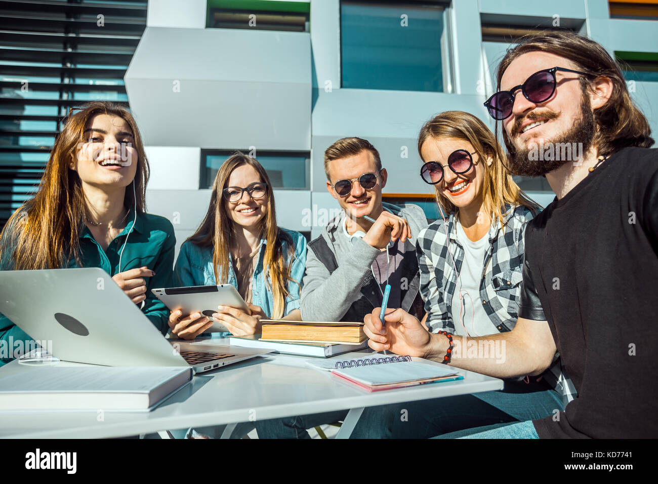 Group of students have study talk on table with laptop and books before ...