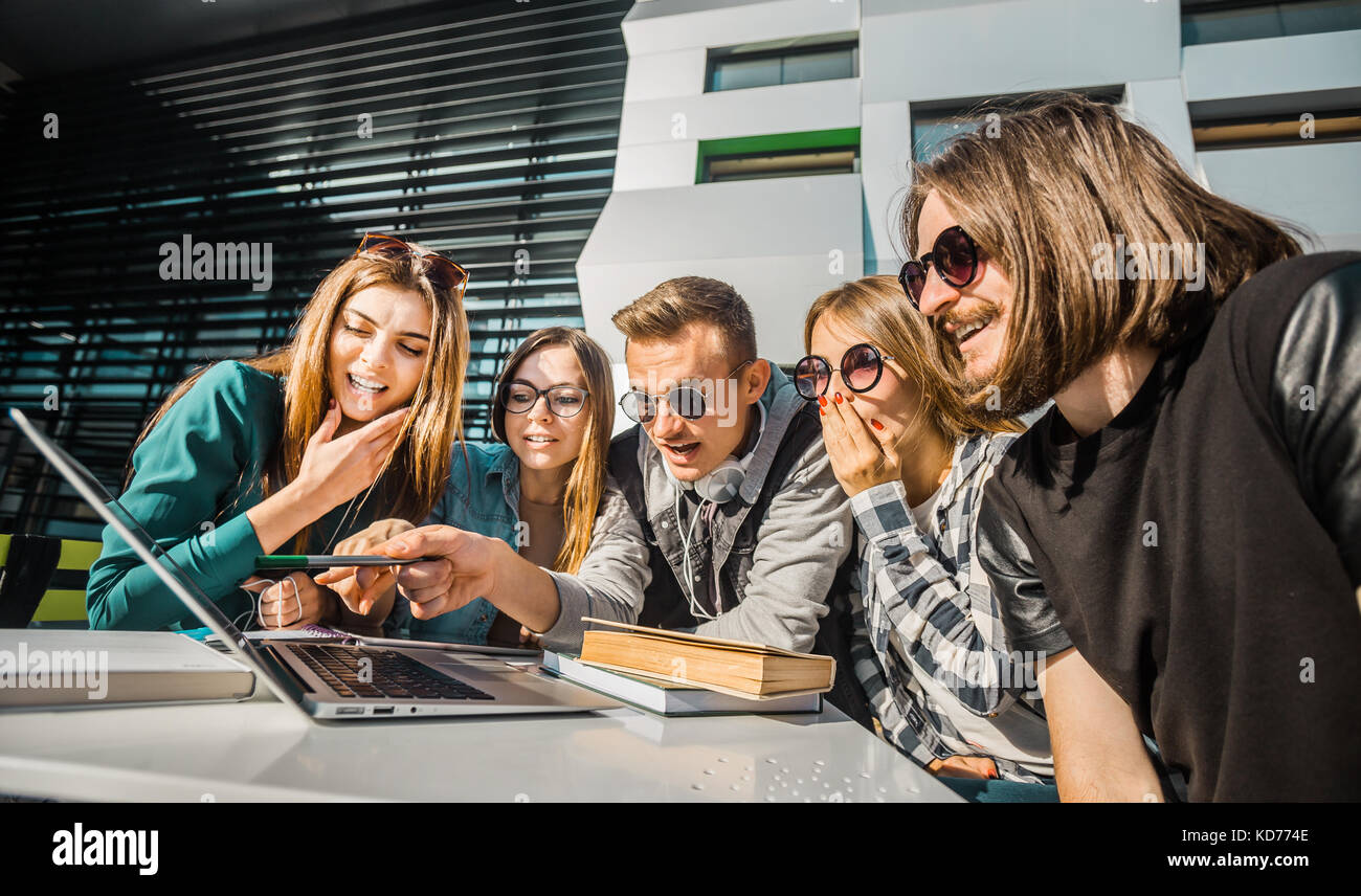 Group of wondering students have study talk on table with laptop and ...