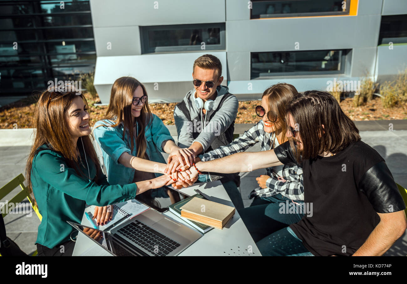 Teamwork cooperation emotions of group of students, hands stick ...