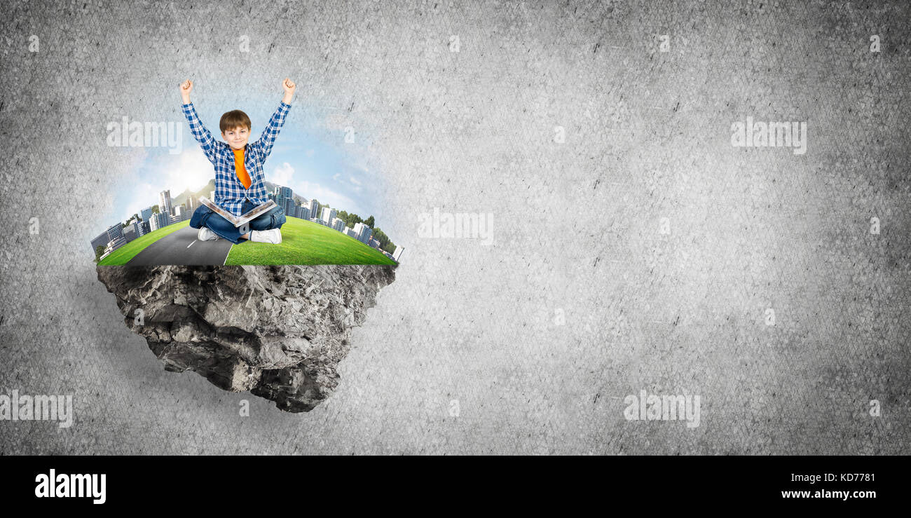Cute boy of school age with book exploring this great world Stock Photo ...
