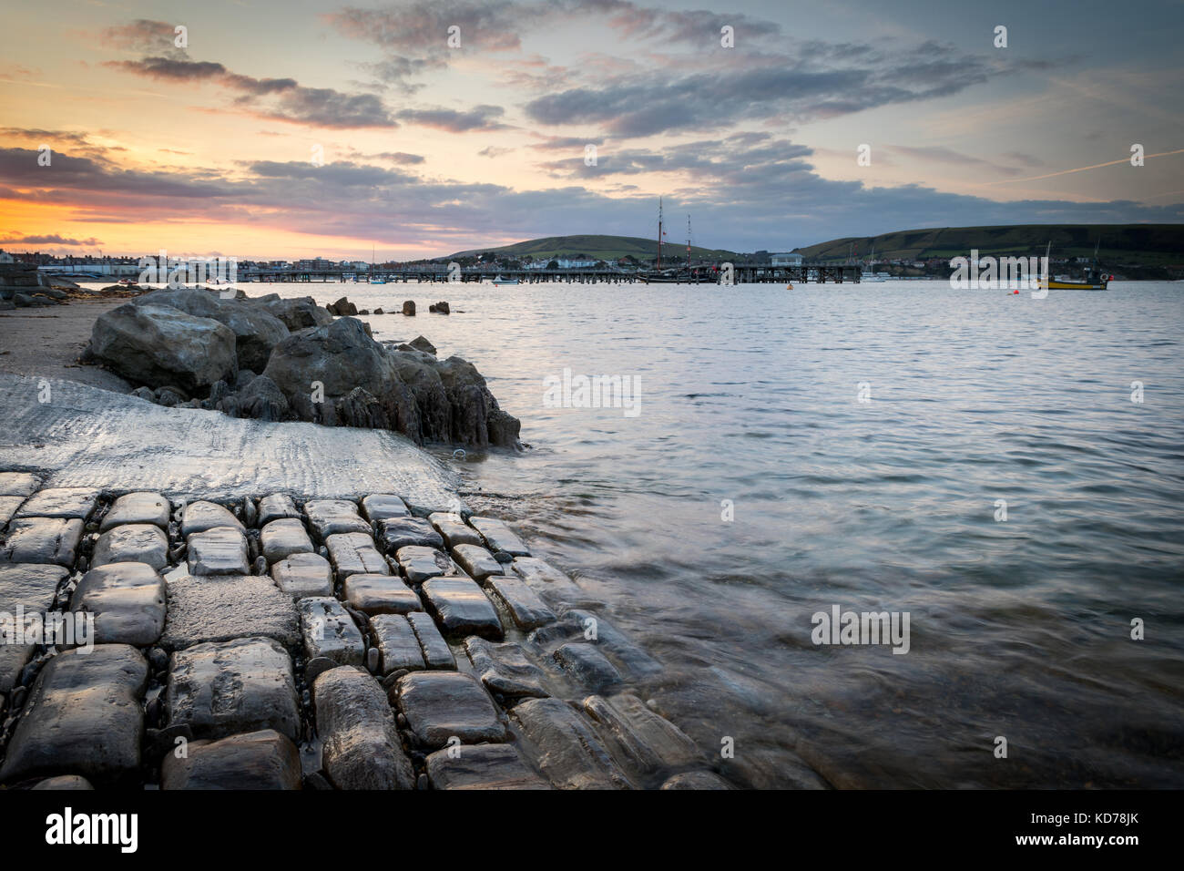 sunset over cobbled slipway in bay Stock Photo - Alamy