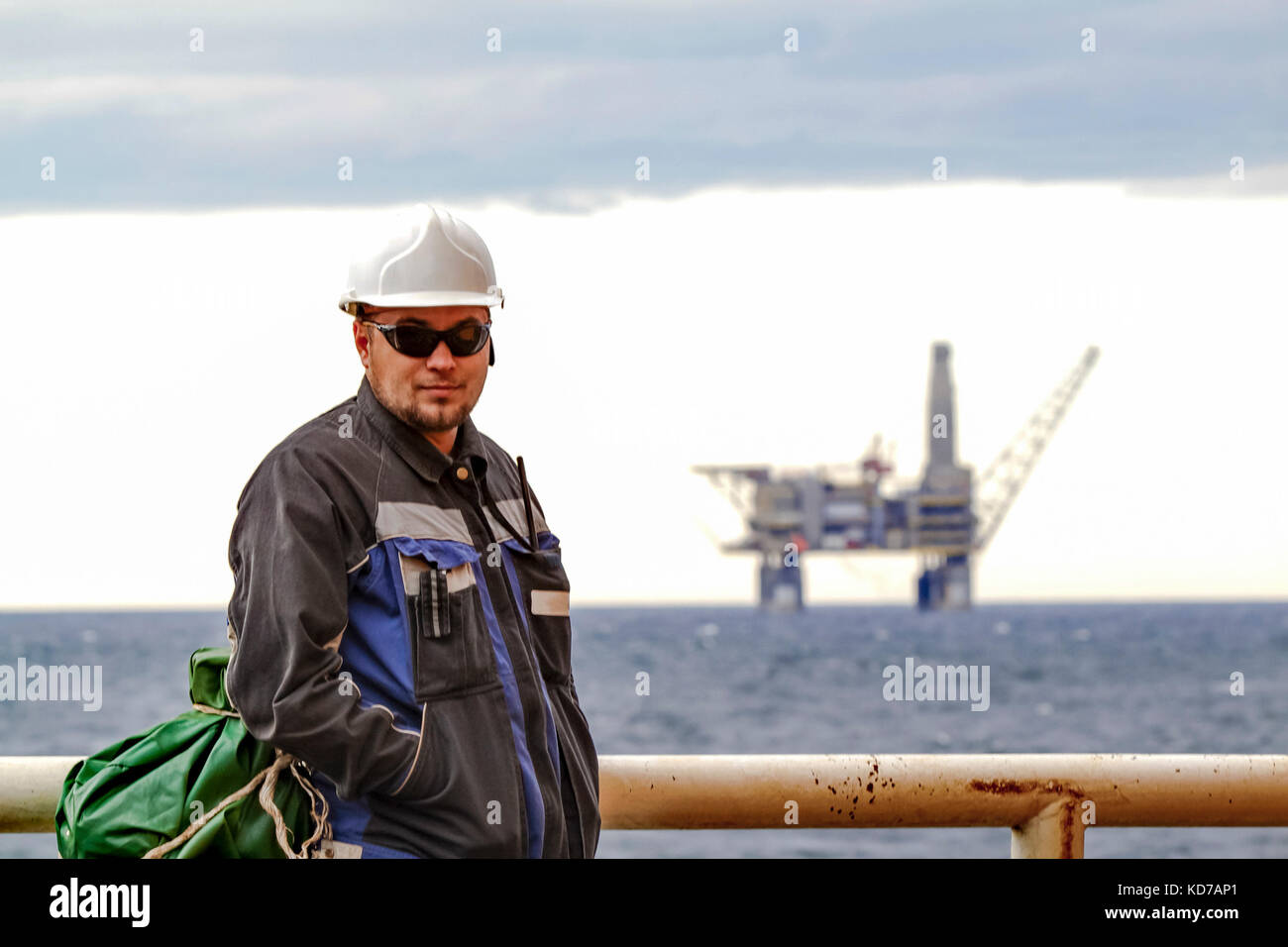 Oilman shift workers on the deck of the ship on the background offshore ...