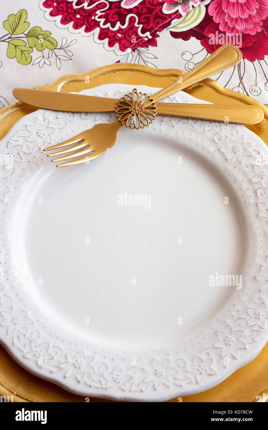 christmas place setting, table ready for lunch, on golden plates and ...