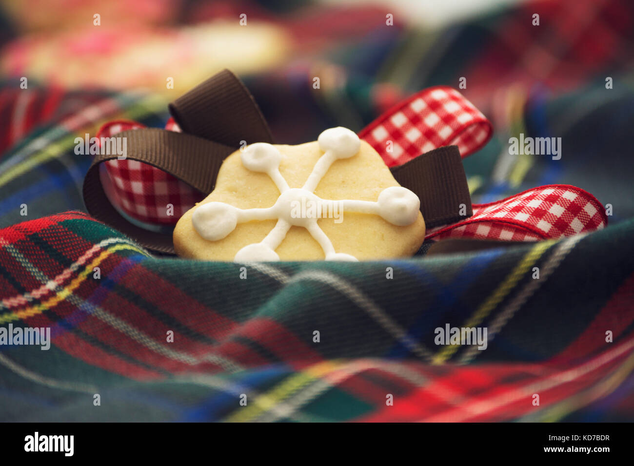 Christmas cookie decorated candy on red and blue tartan fabric, and ...