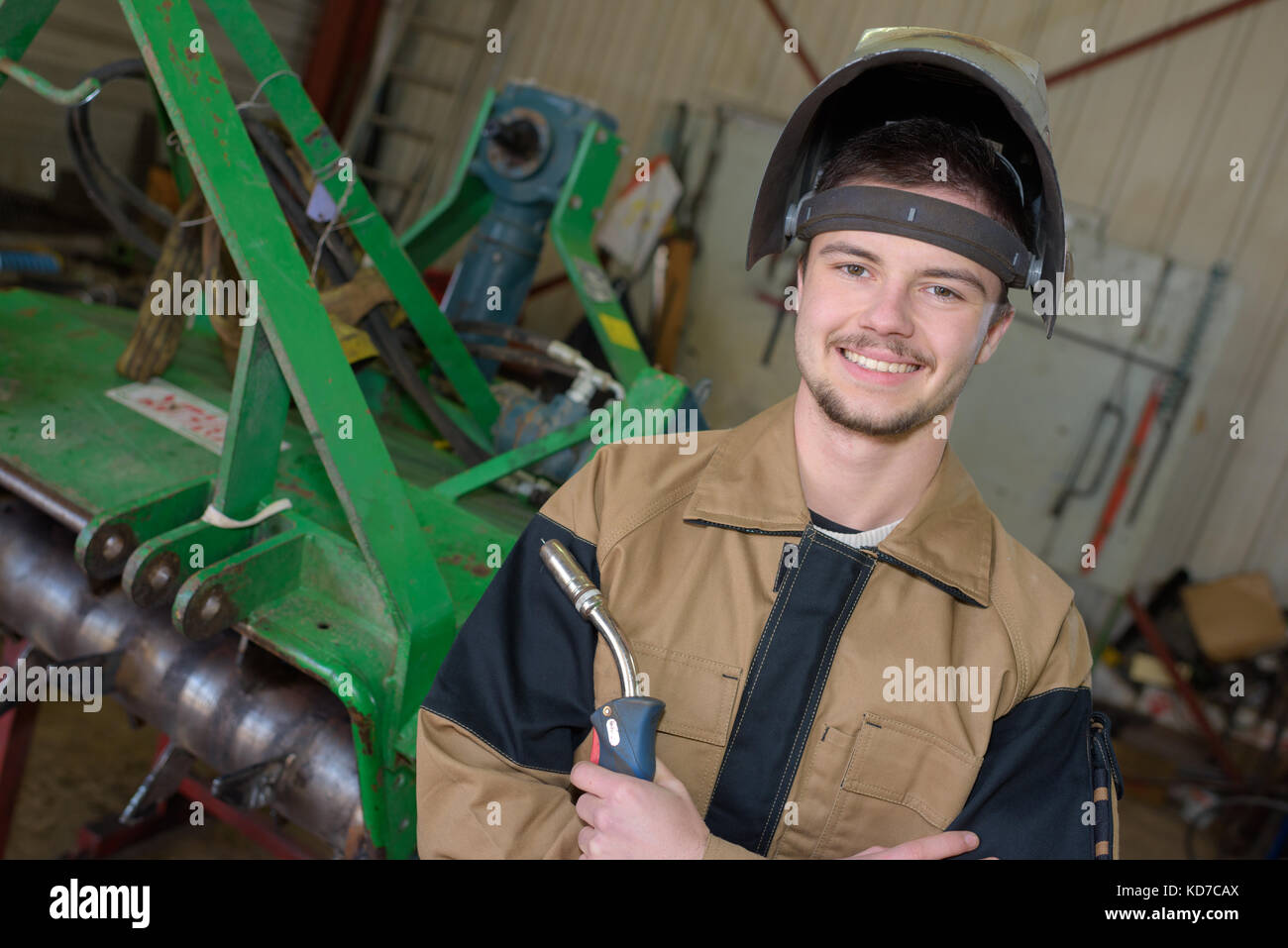 happy apprentice welder at work in the plant Stock Photo - Alamy