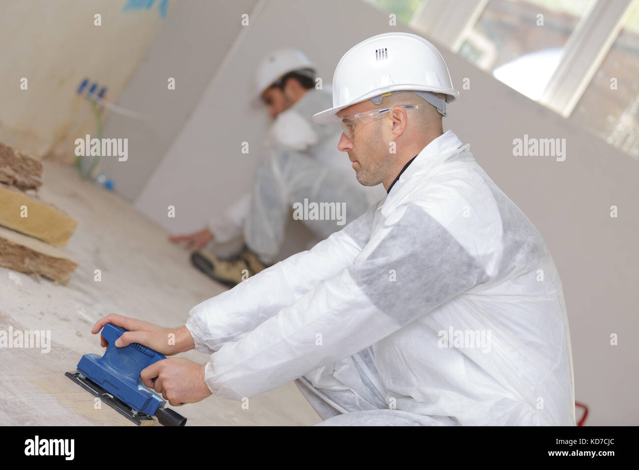 Man sanding surface of floor Stock Photo - Alamy