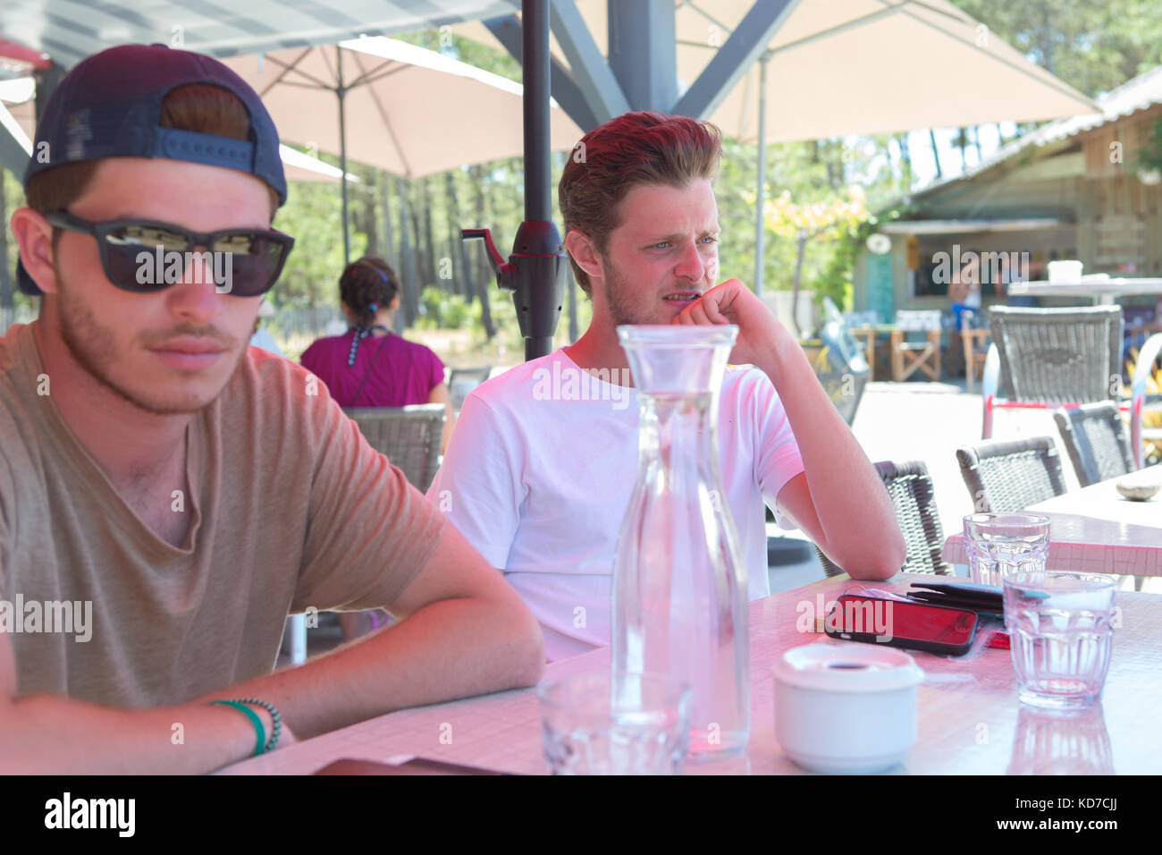 young men having lunch outdoors restaurant Stock Photo - Alamy