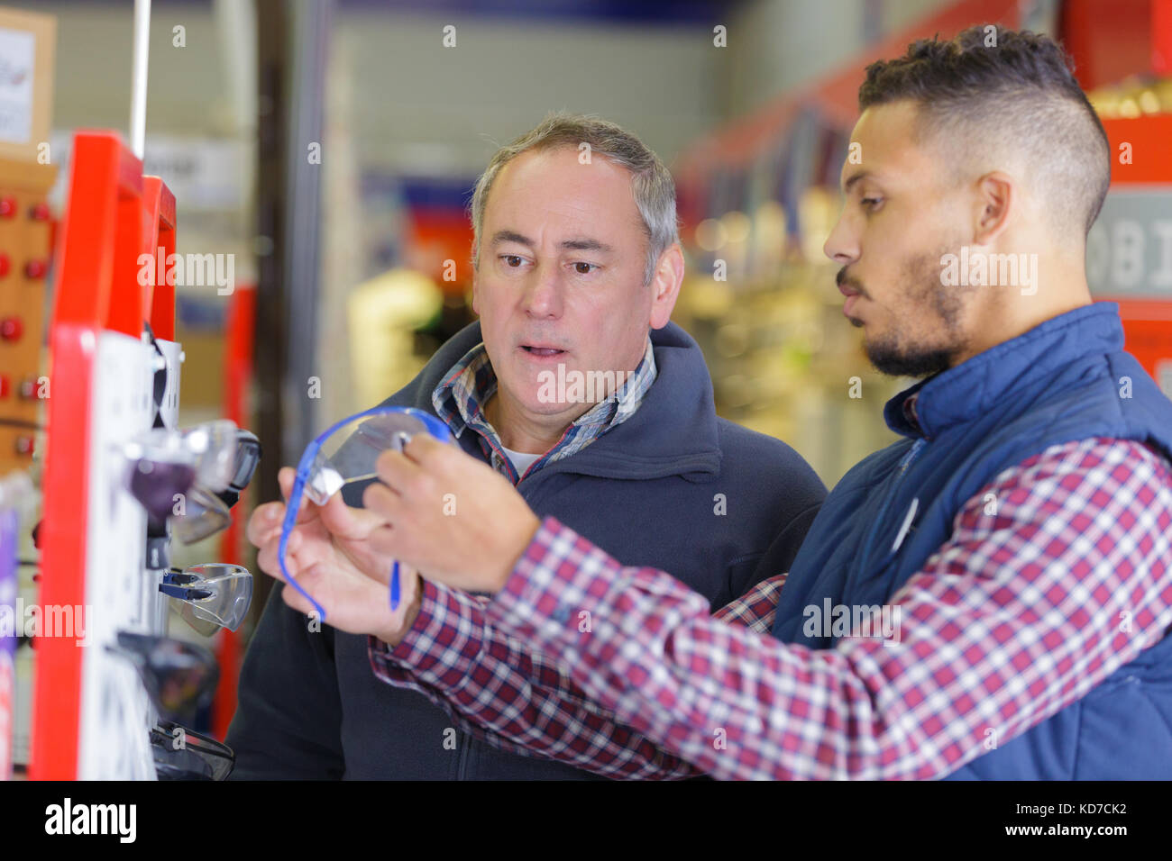 assistant with customer in diy hardware store Stock Photo - Alamy