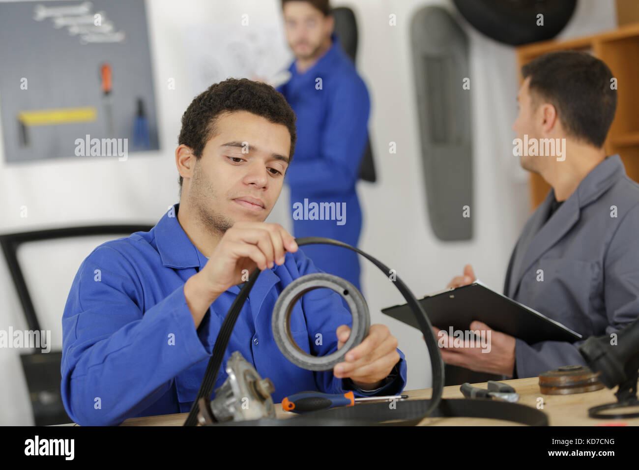 young apprentice checking cables Stock Photo - Alamy