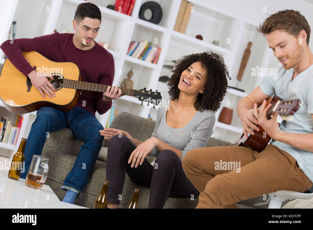 Group three friends play guitar hi-res stock photography and images - Alamy