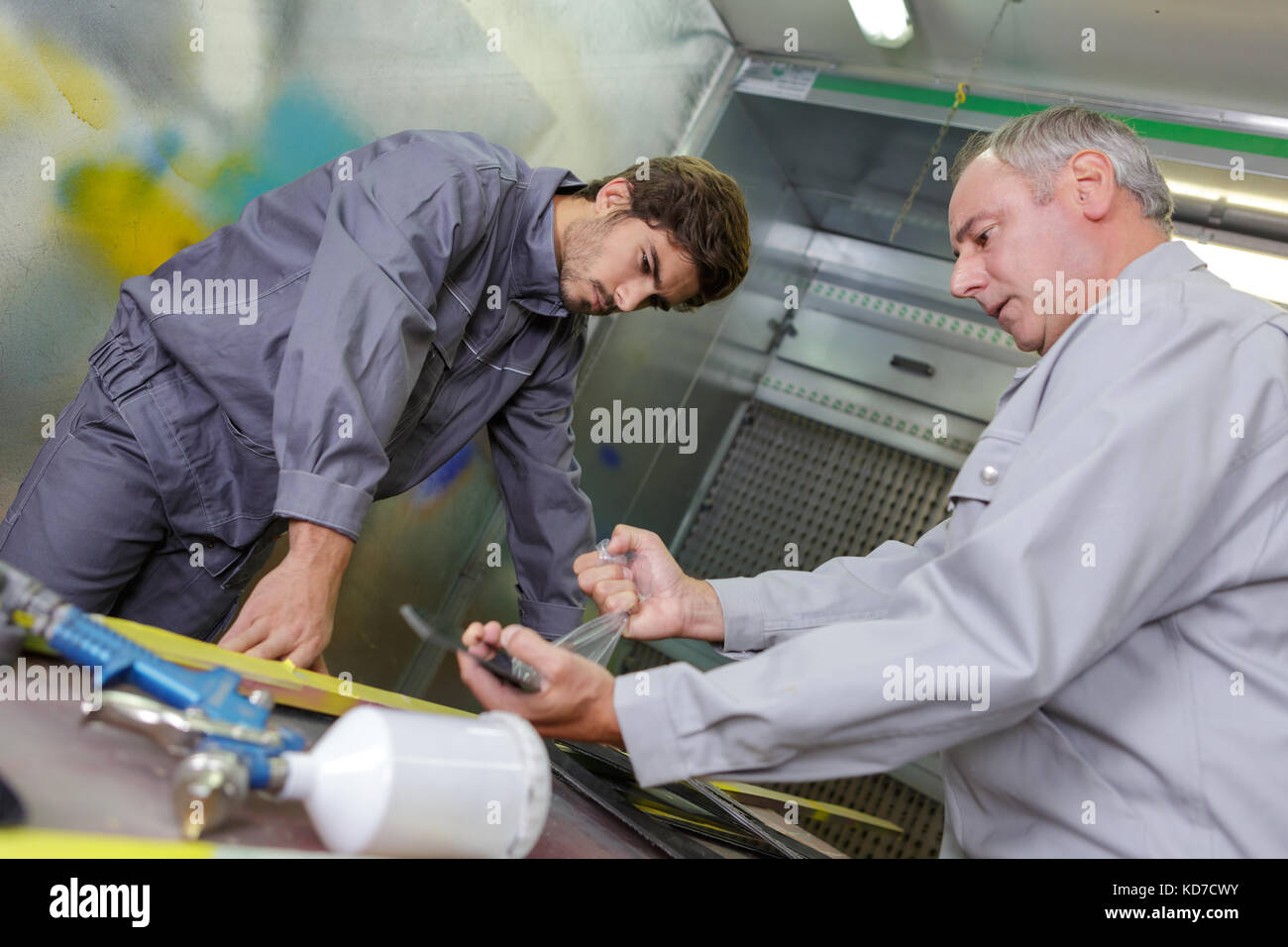 Men in paint spraying area Stock Photo - Alamy