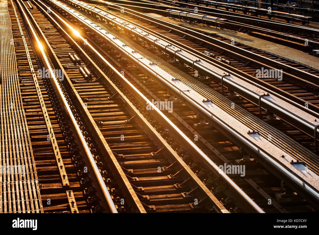 Sun reflections on railroad at sunset Stock Photo - Alamy