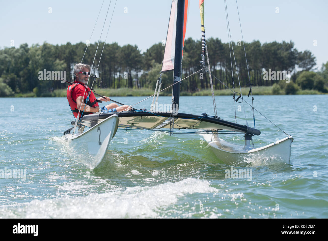 man sailing with sails out on a sunny day Stock Photo - Alamy