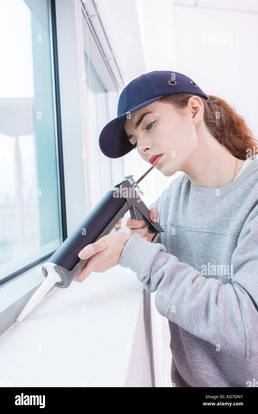 female construction worker installing window in house Stock Photo - Alamy