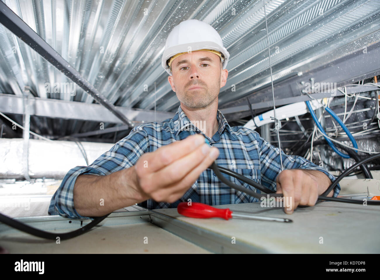 electrician wiring inside ceiling Stock Photo - Alamy