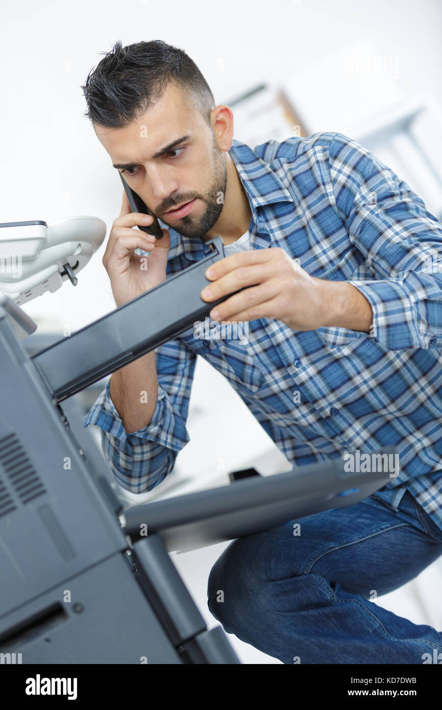 man inspecting the printing machine Stock Photo - Alamy