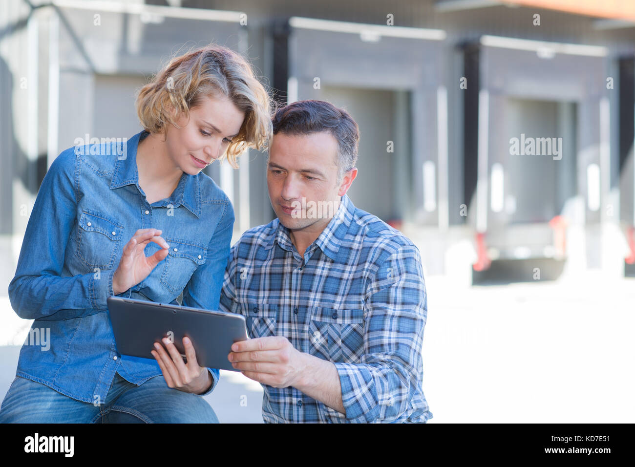 customer standing with construction worker outside Stock Photo - Alamy
