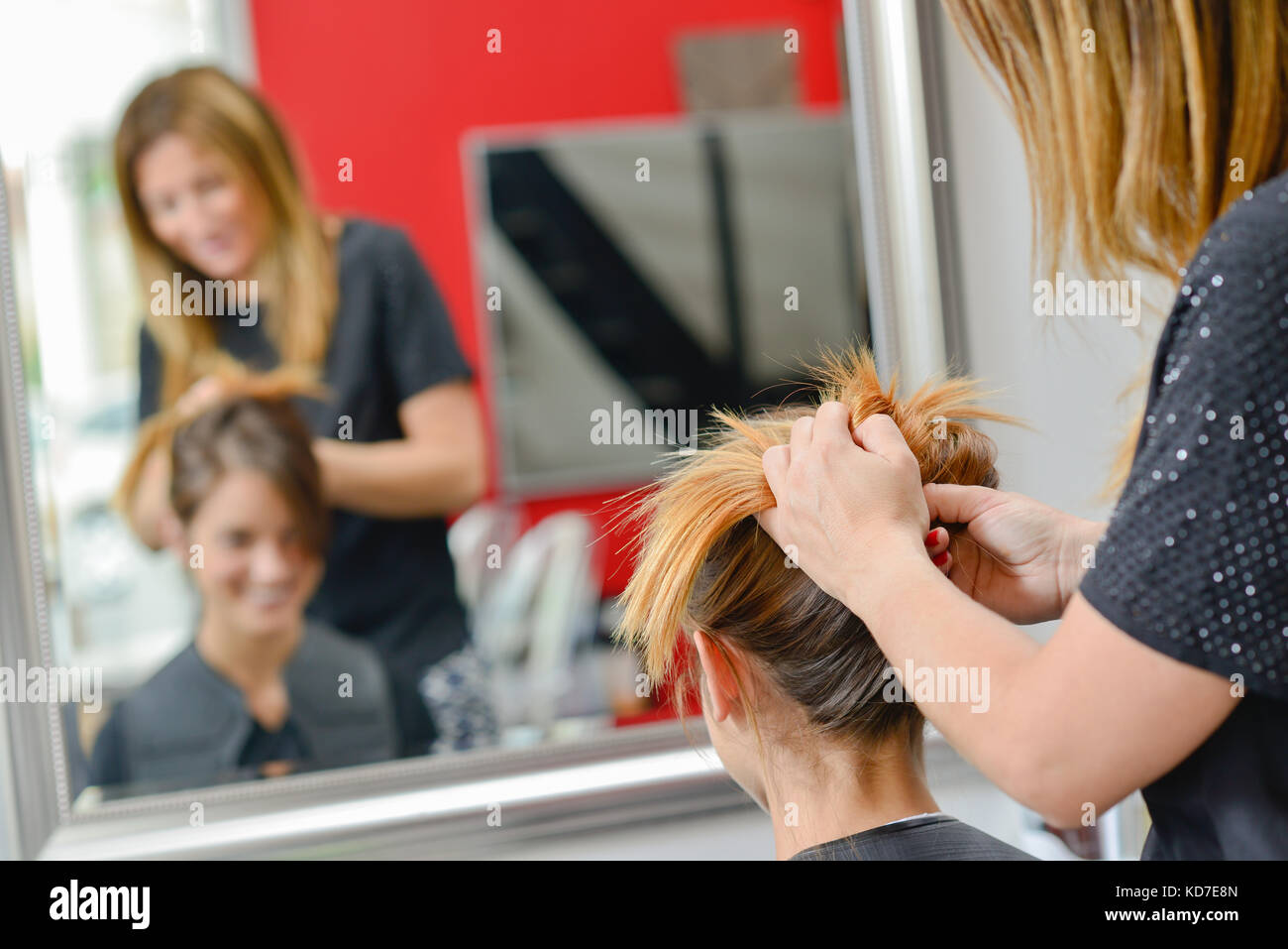 Having her hair styled Stock Photo - Alamy