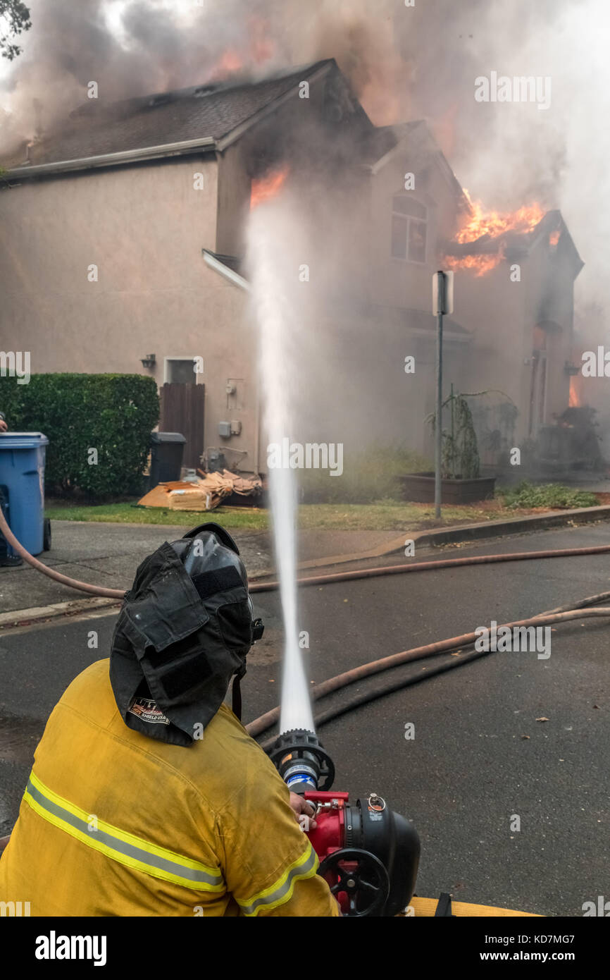 Firefighters defending home on fire. Sonoma County, California, United ...