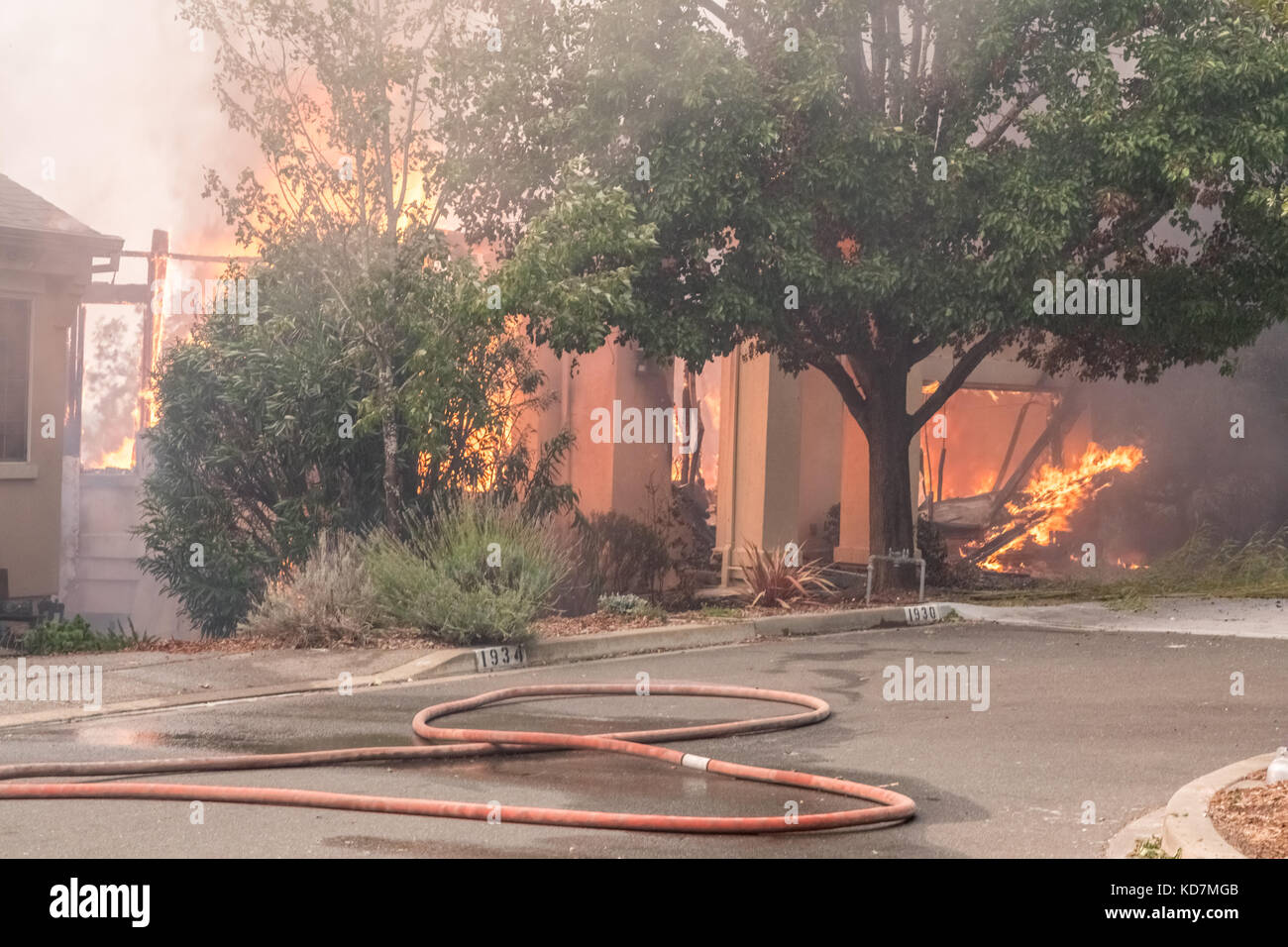 Firefighters defending home on fire. Sonoma County, California, United ...
