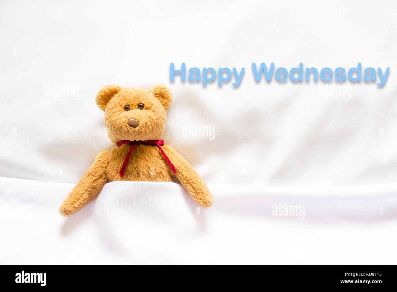 Teddy Bear lying in the white bed with message " Happy Wednesday Stock ...
