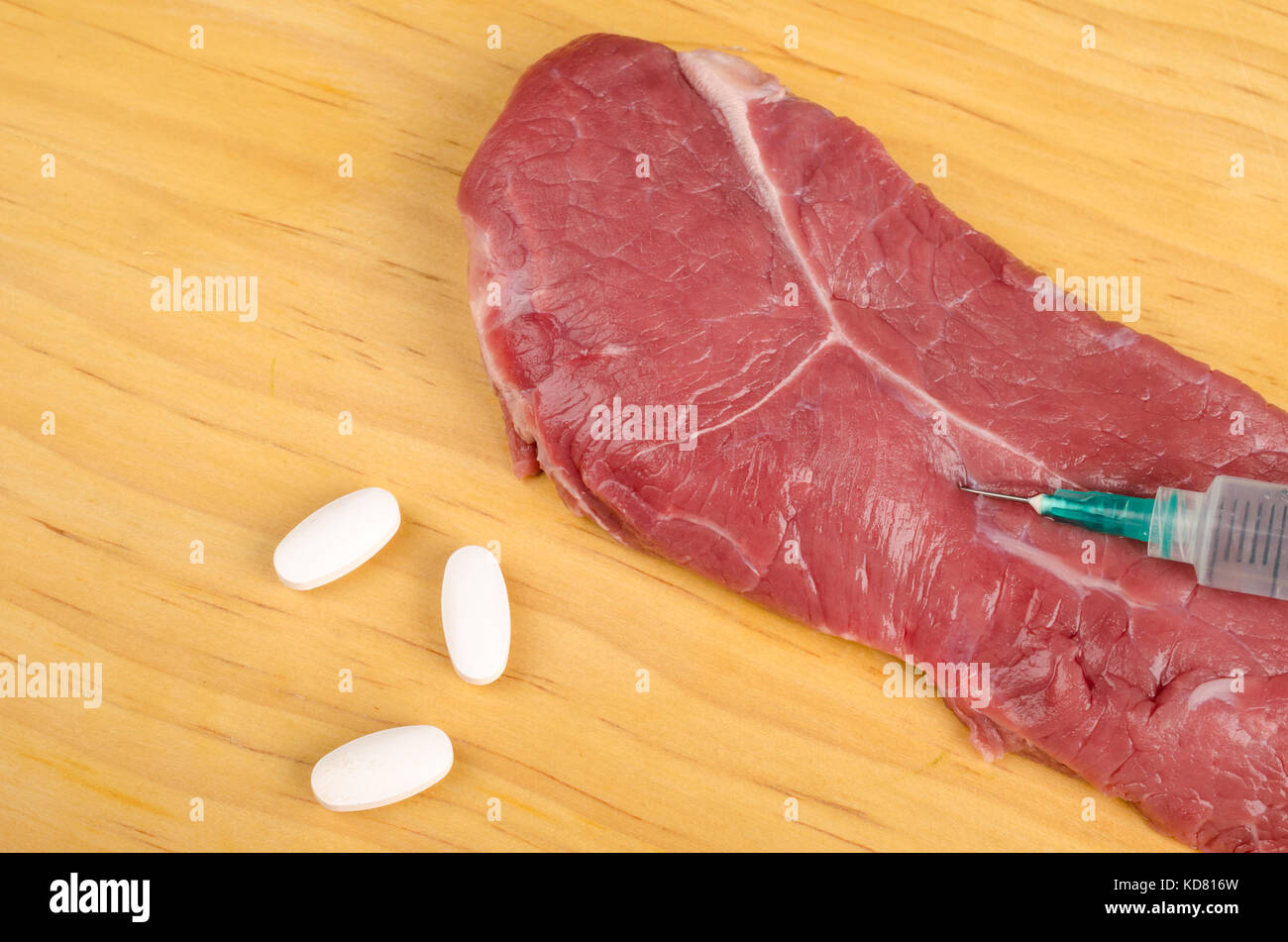 Hormones being injected in a beef steak, a conceptual food manipulation ...