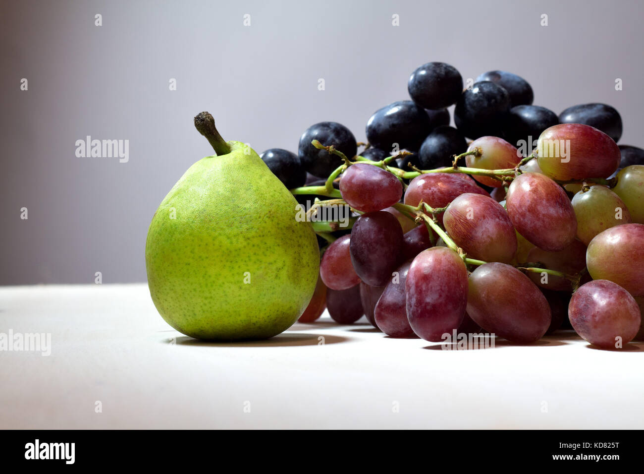 Still life with pear and grapes Stock Photo - Alamy