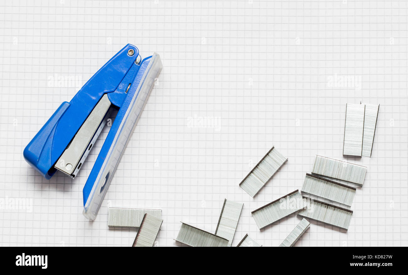 Blue Stapler and Piles of office Staples on Piece of Paper, Closeup ...
