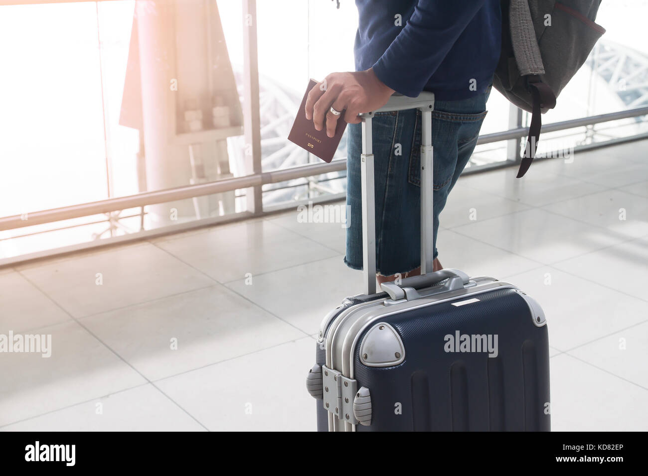 Close up of man hand holding passport and luggage suitcase at airport ...