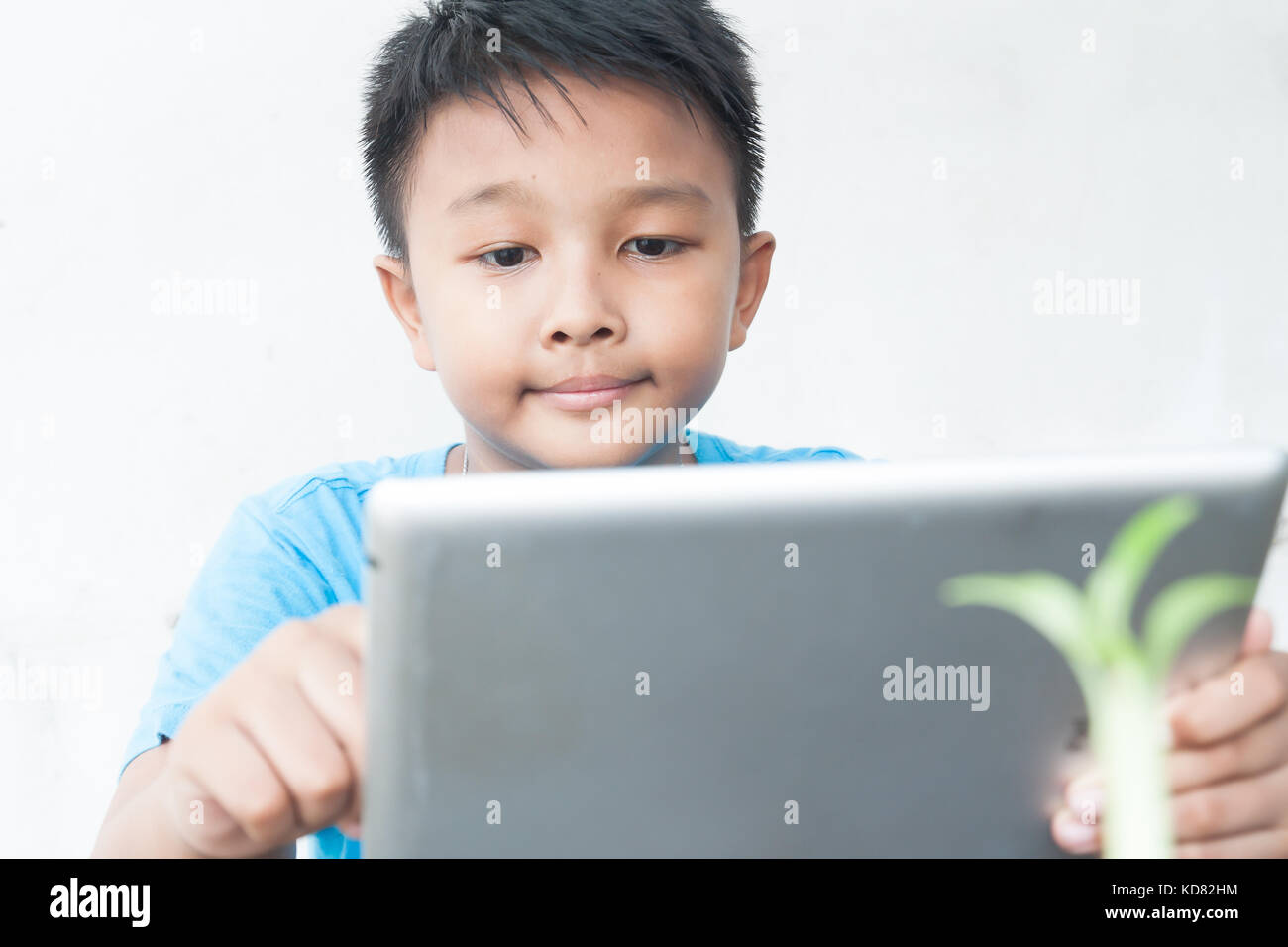 Asian boy using tablet, Happy lifestyle with technology Stock Photo - Alamy