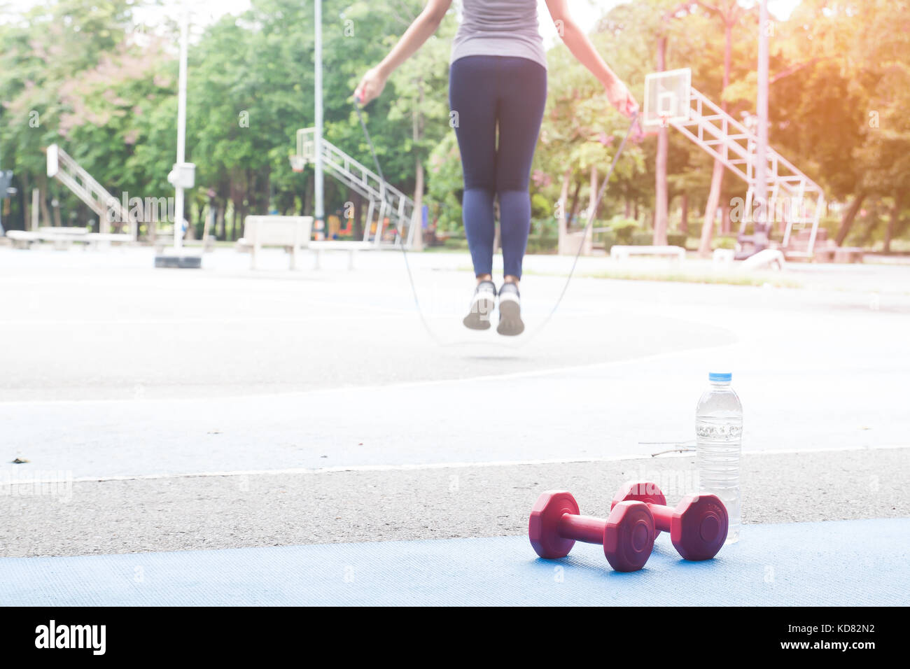 Attractive woman jumping with rope outdoor in the park, Healthy and ...