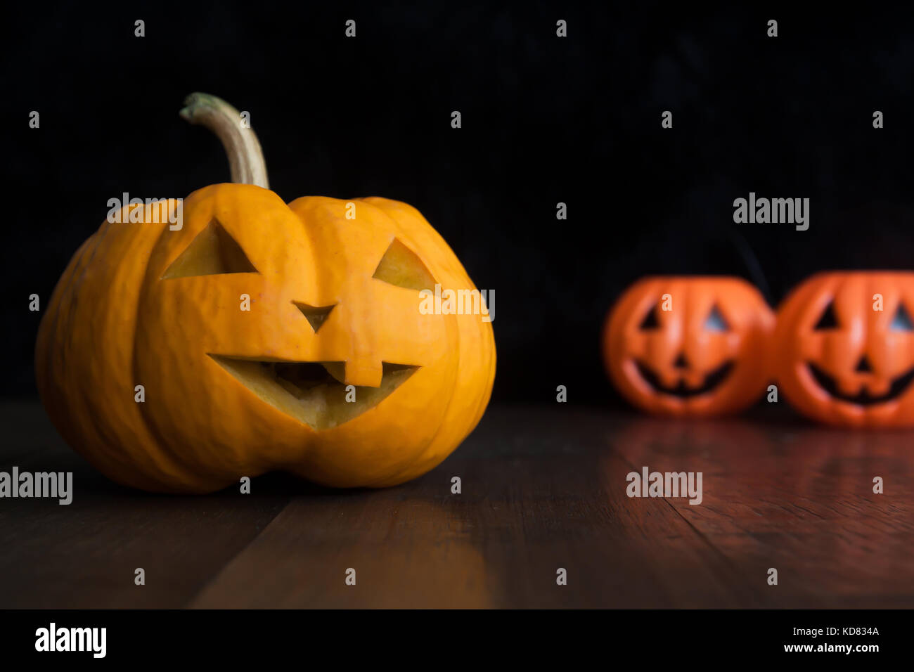 Halloween still life with pumpkins on wooden floor and dark background ...