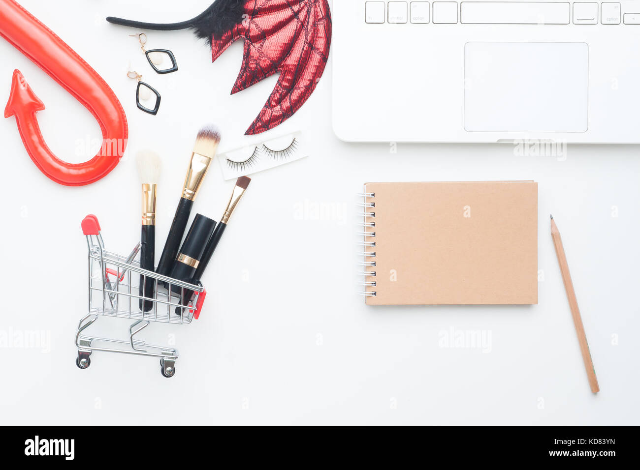 Beauty items in shopping cart with Halloween costume, Laptop computer ...