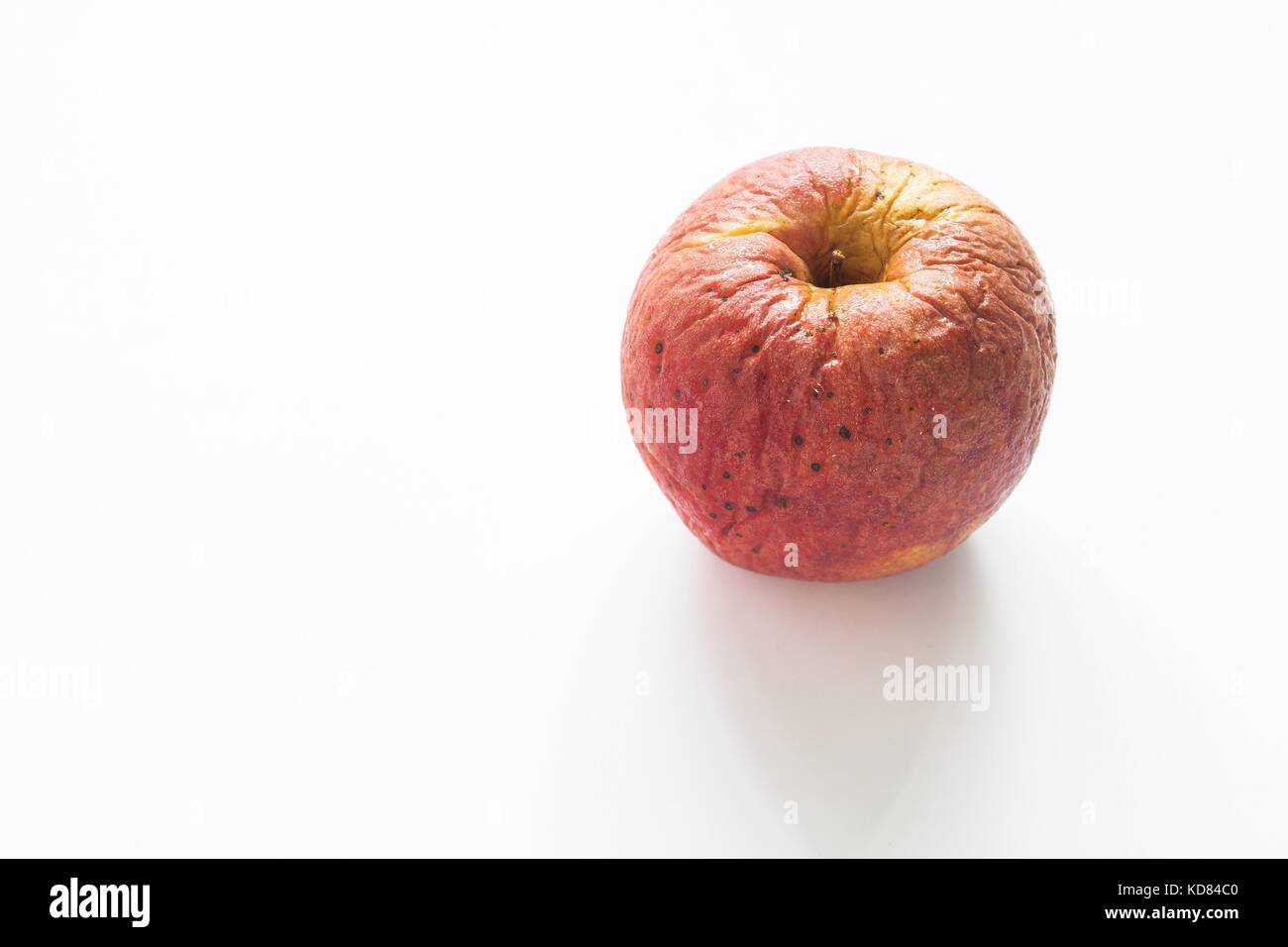 Spoiled apple on white background Stock Photo - Alamy
