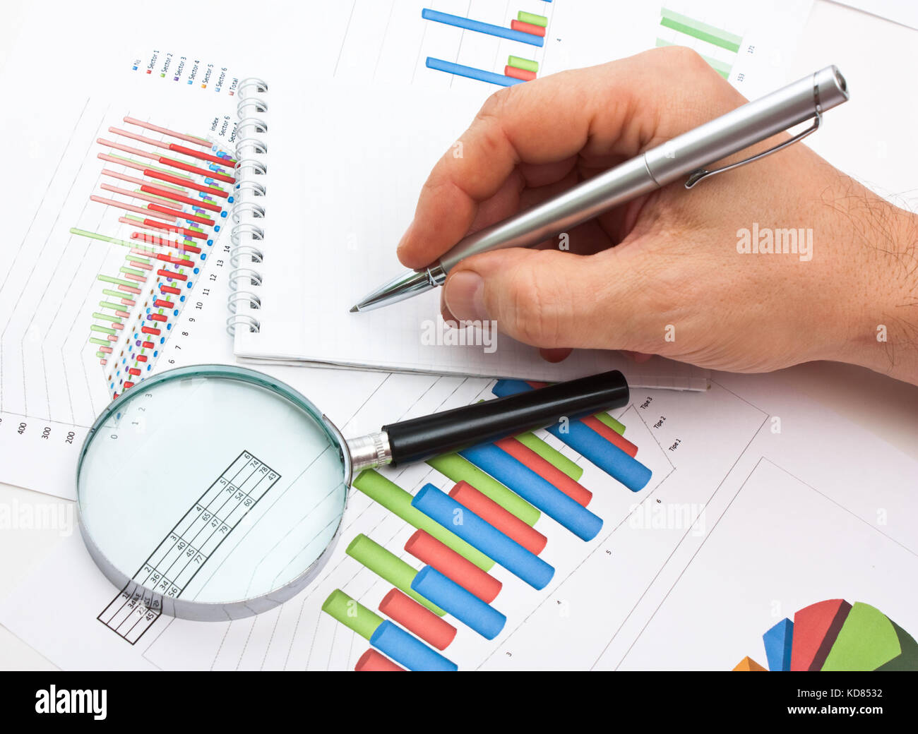 pen in hand and working paper chart Stock Photo - Alamy