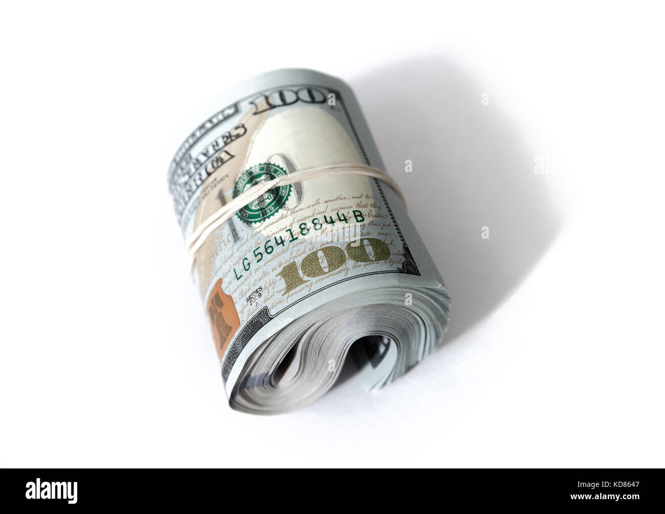 USA currency, roll of One Hundred Dollars lays isolated on white ...