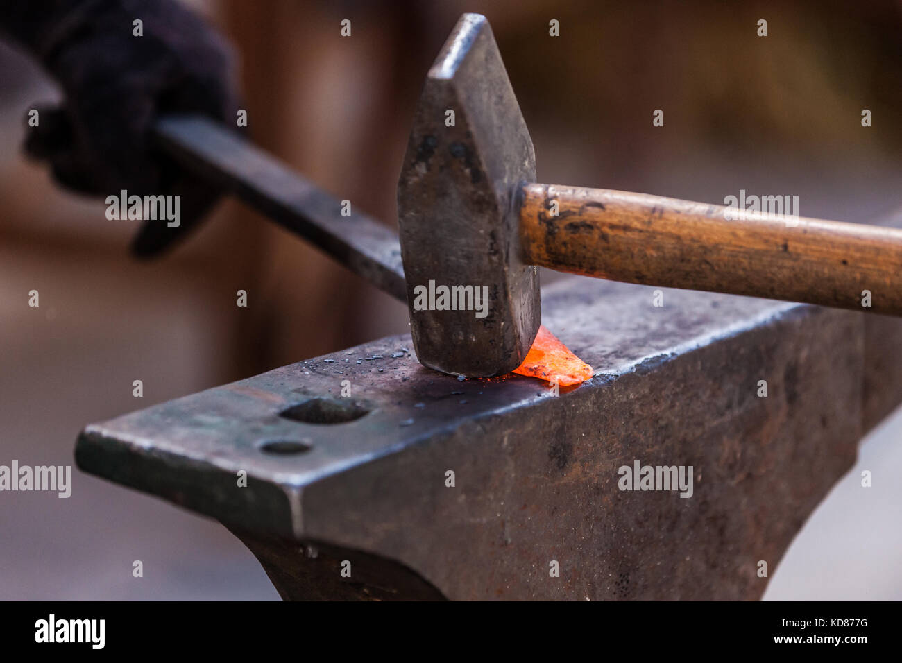 Blacksmith working on metal on anvil at forge detail shot Stock Photo ...