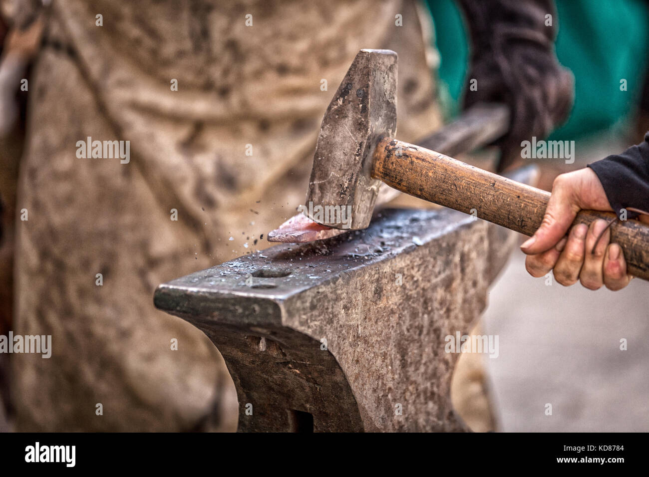 Blacksmith working on metal on anvil at forge detail shot Stock Photo ...