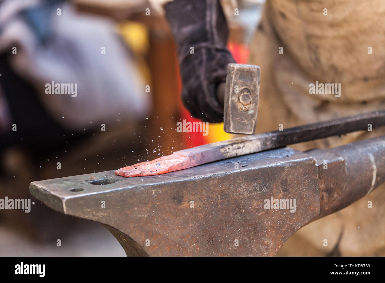 Blacksmith working on metal on anvil at forge detail shot Stock Photo ...