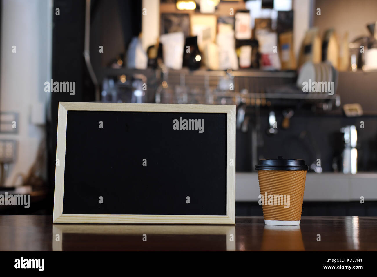 Blank chalkboard menu and cup of coffee on counter in coffee shop. Cafe ...